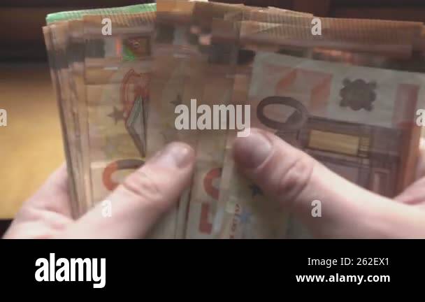 Milan, Italy 1 January 2025: Businessman is counting a stack of euro ...