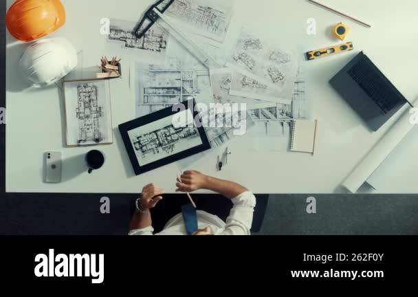 Top down view of civil engineer planning construction and looking at ...