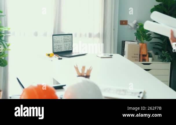 Smart engineer standing and writing idea at blueprint and laptop ...