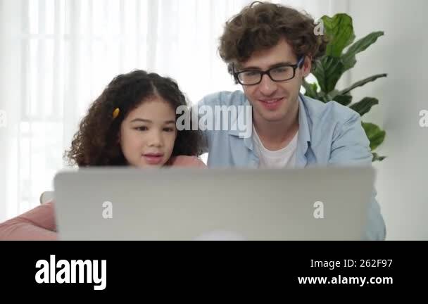 Caucasian father explain programing system while pointing at laptop ...