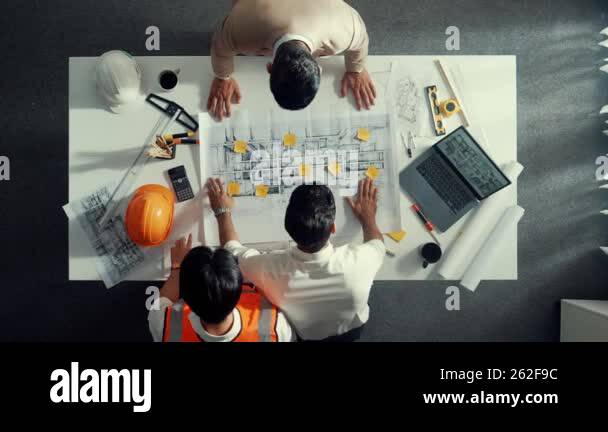 Top down aerial view of smart architect engineer team pointing and ...