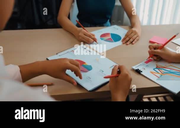 Startup company employee work together, analyze colorful BI dashboard paper with financial data ...