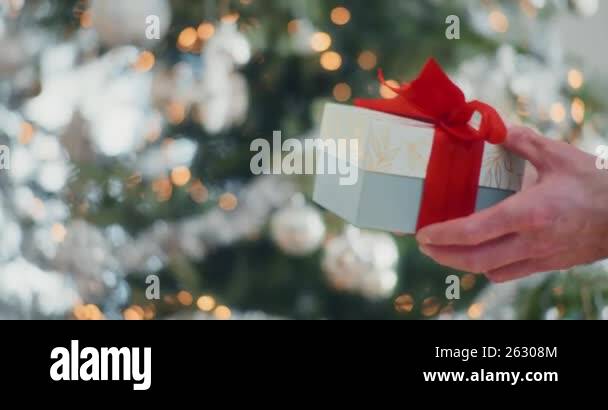 A close-up captures the heartfelt moment of giving a beautifully ...