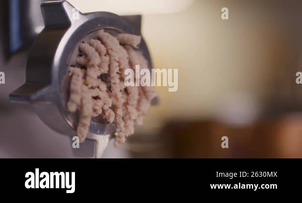 A vivid close-up of raw meat being processed in a grinder Stock Video ...