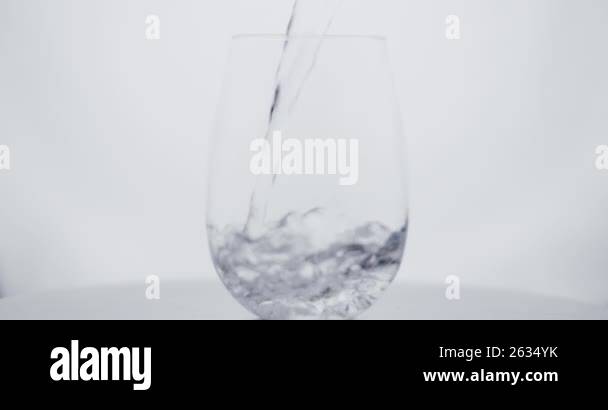 A close-up view of clean, fresh water being poured into a transparent ...