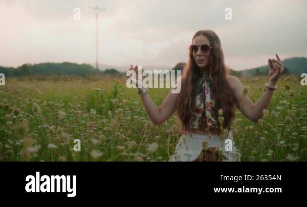 A serene woman meditates surrounded by the beauty of nature, finding ...