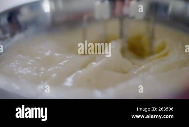 A close-up of a mixer blending pancake batter in a kitchen bowl Stock ...