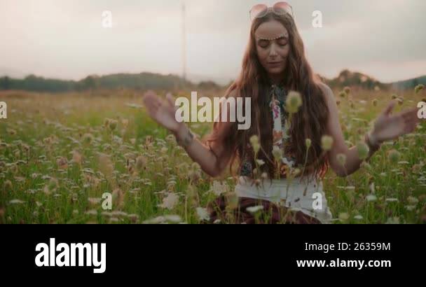 A woman meditates in nature, calming her mind and seeking inspiration ...