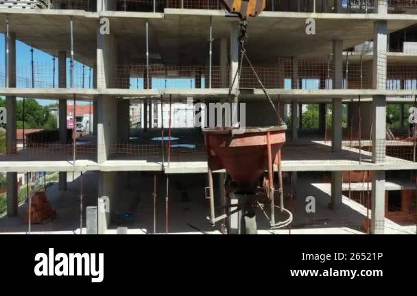 Above view, tower crane as raising upward cone tank, conical metal ...