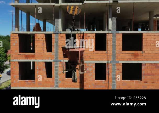 Above view, tower crane as raising upward cone tank, conical metal ...