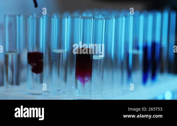 Close-up of a drop of blood falling from a pipette into a test tube in ...