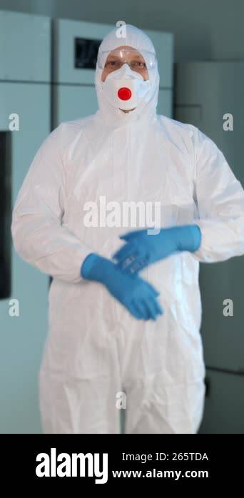 Close-up portrait of a medical worker in a protective suit, goggles and ...