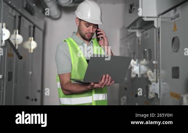 Professional electrical engineer in hard hat and reflective vest ...