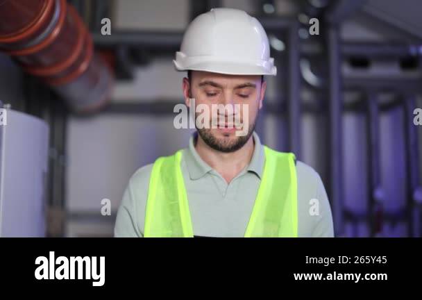 Confident bearded power generation plant worker in hardhat and uniform ...