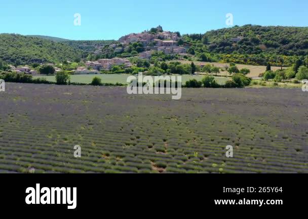 View of Simiane la Rotonde village in Provence, France. Lavender field ...
