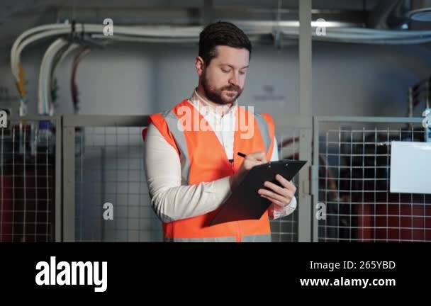 Electrical engineer conducts an inspection of an electrical control ...
