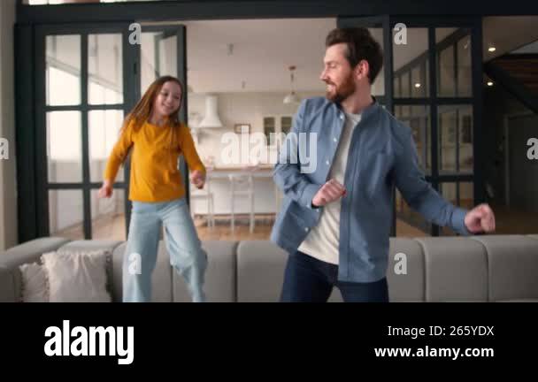 Happy Caucasian dad man father male dancing with little daughter kid ...
