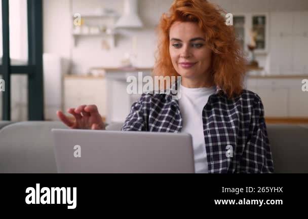 Smiling Caucasian woman on couch happy lady girl female chatting ...