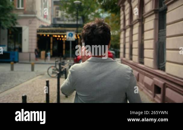 Back view from behind unrecognizable man unknown guy male talking ...