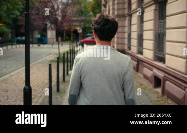 Back view from behind unrecognizable man unknown guy walking outdoors ...