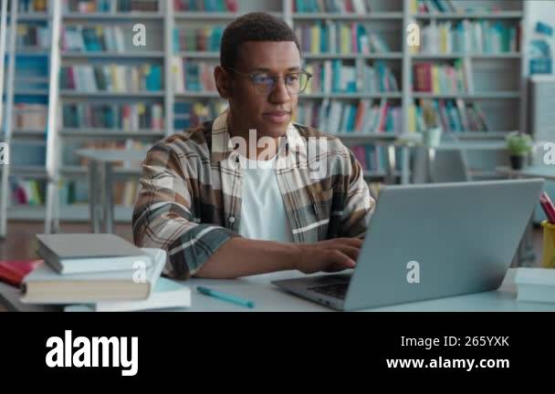 African American man guy male typing browsing laptop online computer ...