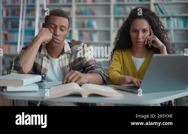 Tired students African American man Latino Arabian woman library ...
