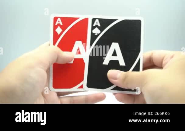 Hand showing all kinds of aces on a deck of playing cards with a white ...
