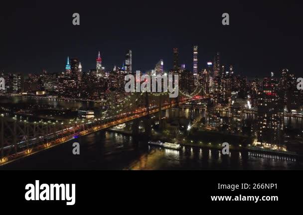 Aerial views of illuminated Queensboro Bridge and New York City skyline ...