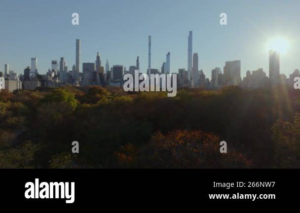 Aerial views of sun shining over Central Park in the fall, highlighting ...