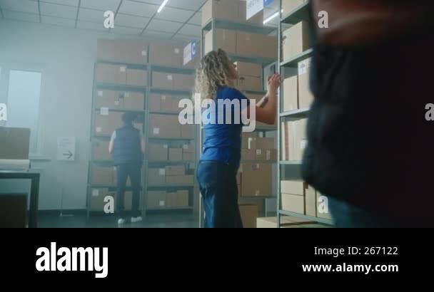 Sorting center multiethnic employees working in warehouse of online store. Female logistics ...