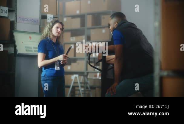 Female logistics manager with tablet computer talks to colleagues, gives instructions for ...