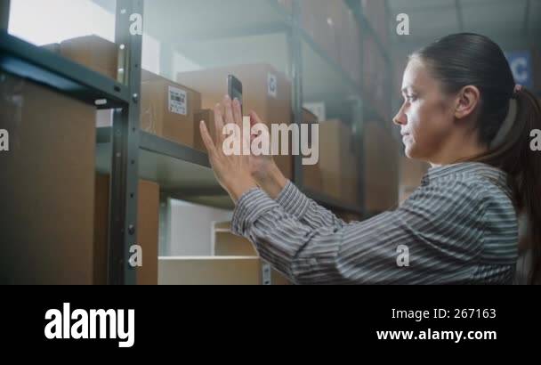Close Up of Female Sorting Center Employee Scanning Cardboard Box with ...