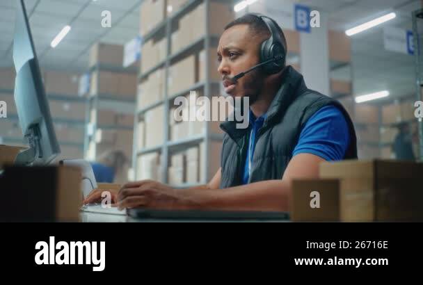 African American logistics customer support specialist in headset talks ...