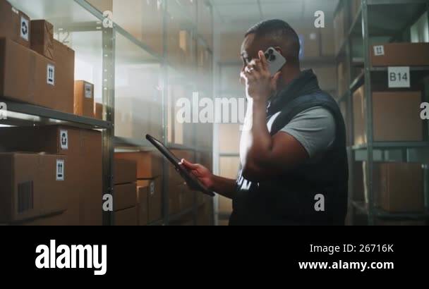 African American Logistics Coordinator with Tablet Computer Chats with ...