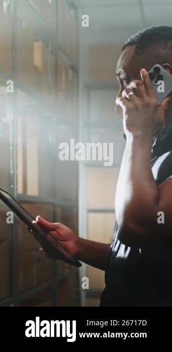 African American Logistics Coordinator with Tablet Computer Chats with ...