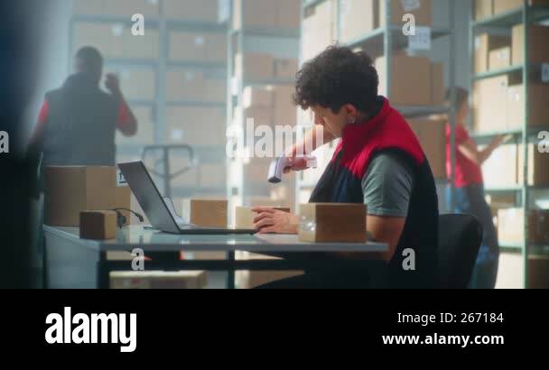 Parcel processing specialist scans packages using barcode scanner ...