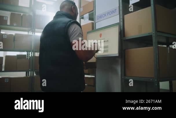 African American Parcel Processing Specialist Scans Cardboard Box at ...
