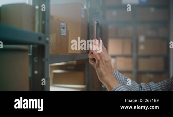 Close Up of Warehouse Associate Scanning Cardboard Box with E-Commerce ...