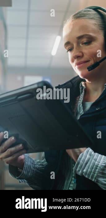 Female Customer Support Specialist in Logistics in Headset Talks on Call with Client, Uses ...