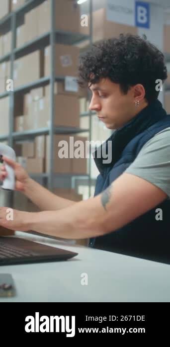 Parcel processing specialist scans packages using barcode scanner ...