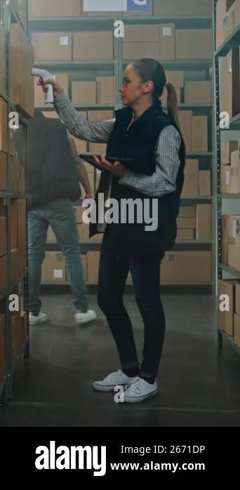 Female Warehouse Associate Scans Cardboard Boxes with E-Commerce Goods with Scanner, Checks ...