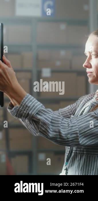Female Warehouse Associate Scans Cardboard Box with E-Commerce Online Goods on Shelf Using ...