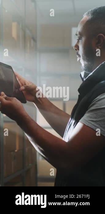 African American Warehouse Associate Scans Cardboard Box with E-Commerce Online Orders Using ...