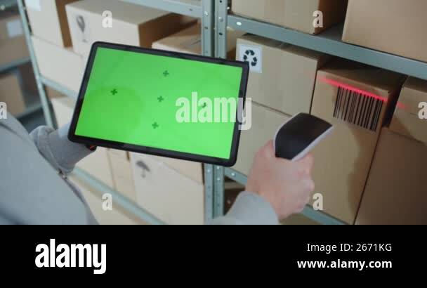 Postal Warehouse Associate Scans Code on Cardboard Box with Barcode Scanner, Checks Parcel ...