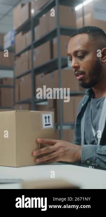 Postal service: African American logistics specialist scans parcel with ...