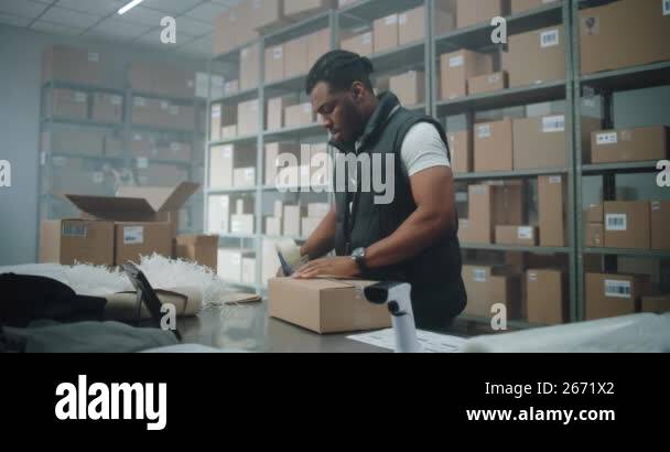 African American Postal Worker, Shipping Clerk Packs Cardboard Parcel ...