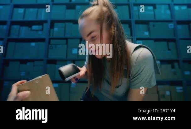 Positive Female Warehouse Employee Looking at Camera, Scanning ...