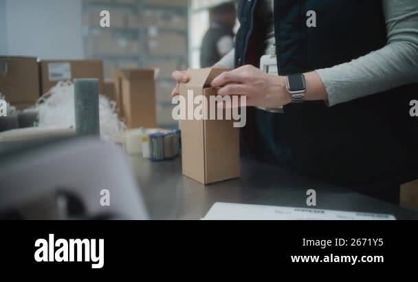 Close Up of Female Postal Worker, Shipping Clerk Packing Cardboard ...