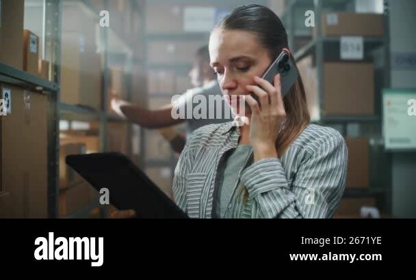 Female Logistics Coordinator with Tablet Computer Chats with Customer ...