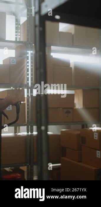 African American Sorting Center Worker Unloads Pallet Truck, Places Cardboard Boxes, Parcels on ...